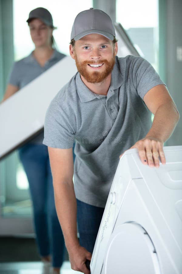 Two Young Male Professional Movers in Uniform Delivery Washing Machine ...