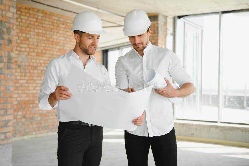 Two Young Man Architect on a Building Construction Site Stock Photo ...