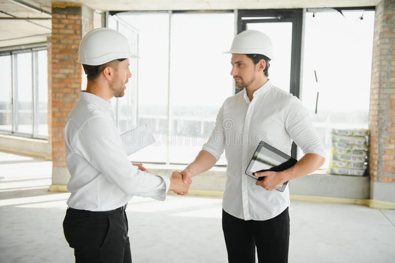 Two Young Man Architect on a Building Construction Site Stock Photo ...
