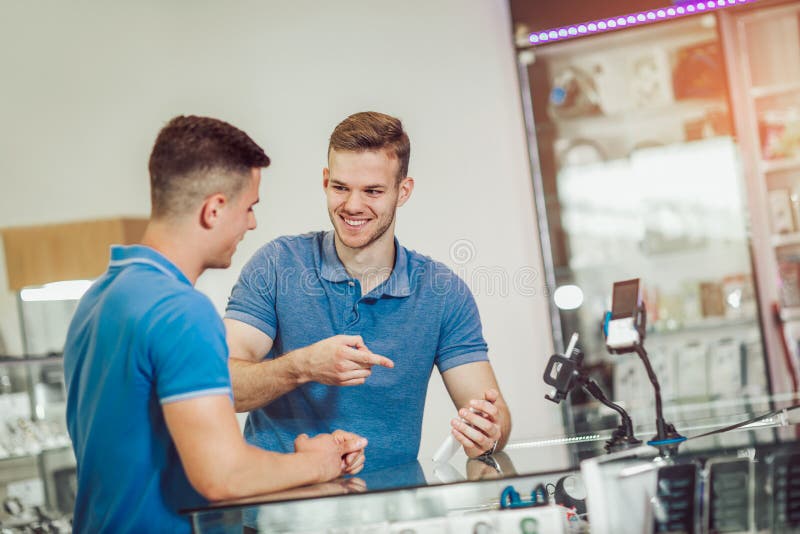 Two Young Men Choosing Smart Phone in the Store Stock Image - Image of ...