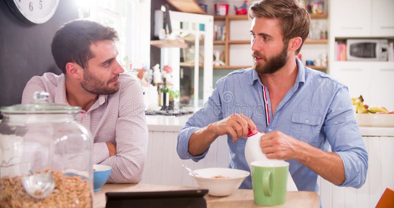 Two Young Men Eating Breakfast in Kitchen Together Stock Image - Image ...