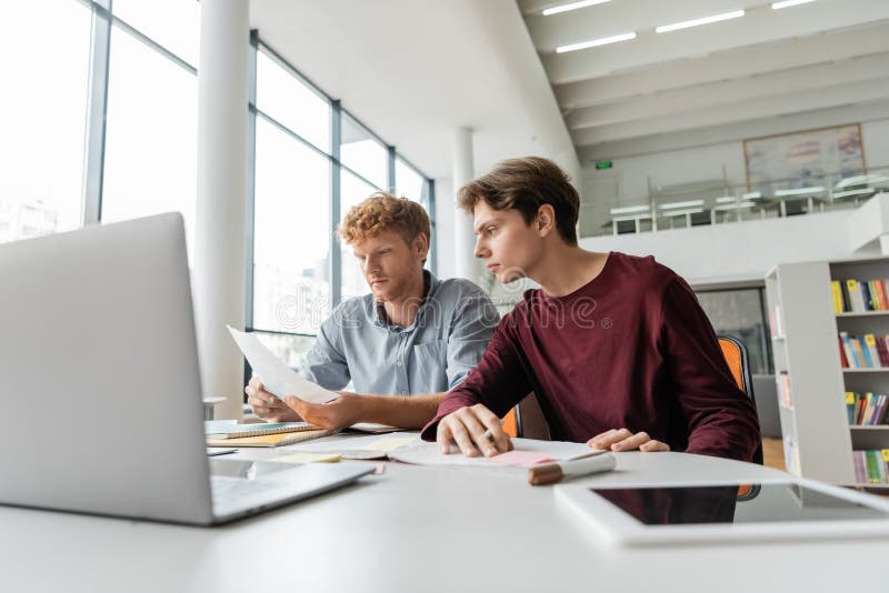 Two Young Men Focus on Laptop Stock Image - Image of teamwork, library ...