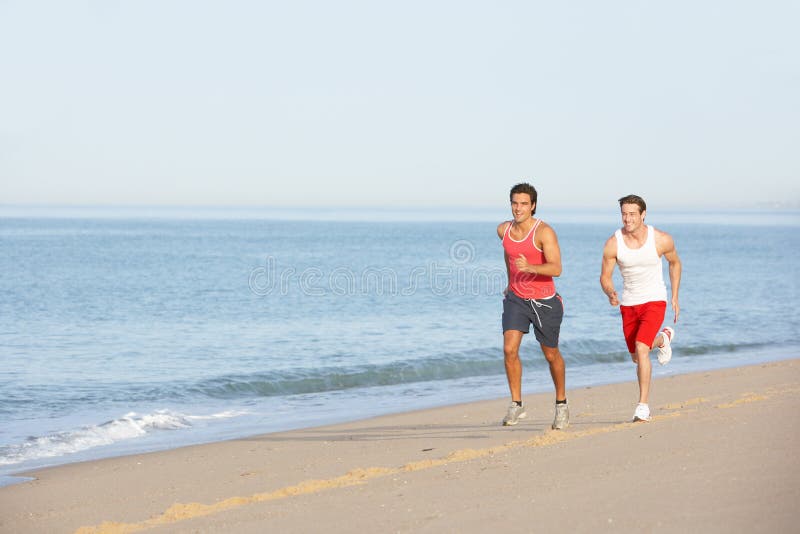 Two Young Men Jogging Along Beach Stock Photo - Image of active ...