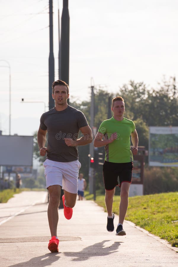 Two Young Men Jogging through the City Stock Image - Image of jogger ...