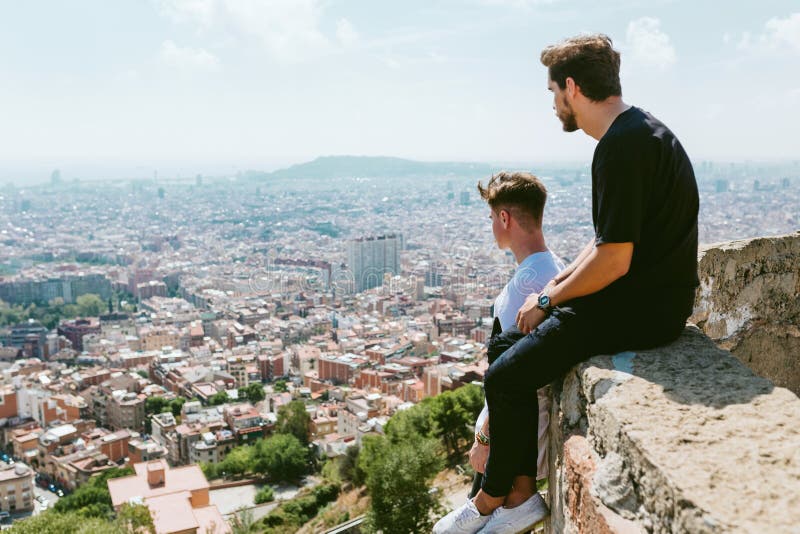 Two Young Men Looking at the Views Form the Top of a Mountain. Stock ...