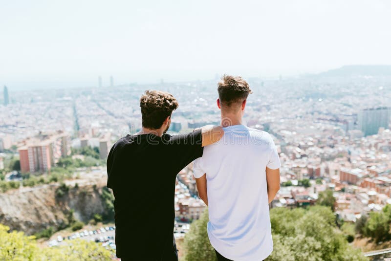 Two Young Men Looking at the Views Form the Top of a Mountain. Stock ...