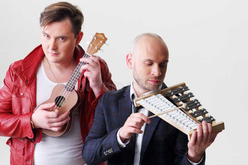 Two Young Men with Musical Instruments, Focus on Stock Photo - Image of ...