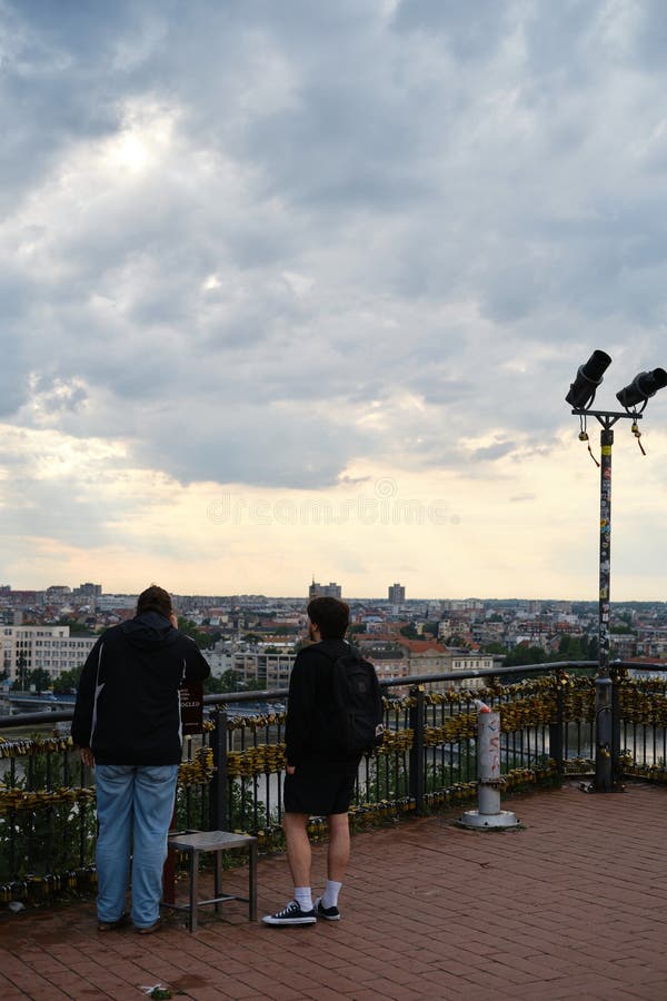 Two Young Men on the Observation Deck Look at the City from a Height ...