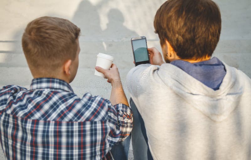 Two Young Men with Phone in Hand Stock Image - Image of millennial ...