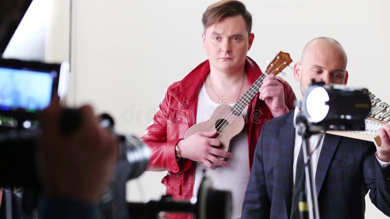 Two Young Men Play Musical Instruments in Front of Stock Video - Video ...