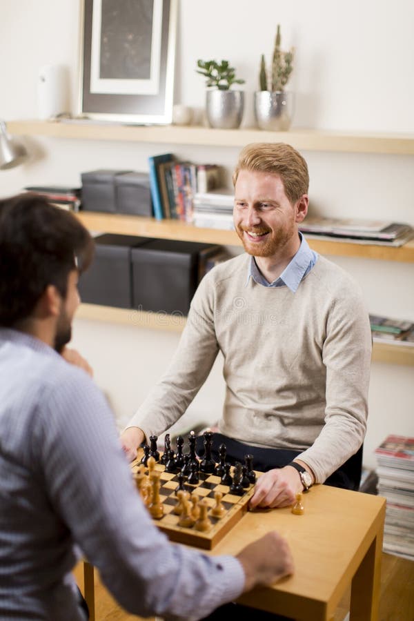 Two Young Men Playing Chess in Room Stock Photo - Image of indoors ...