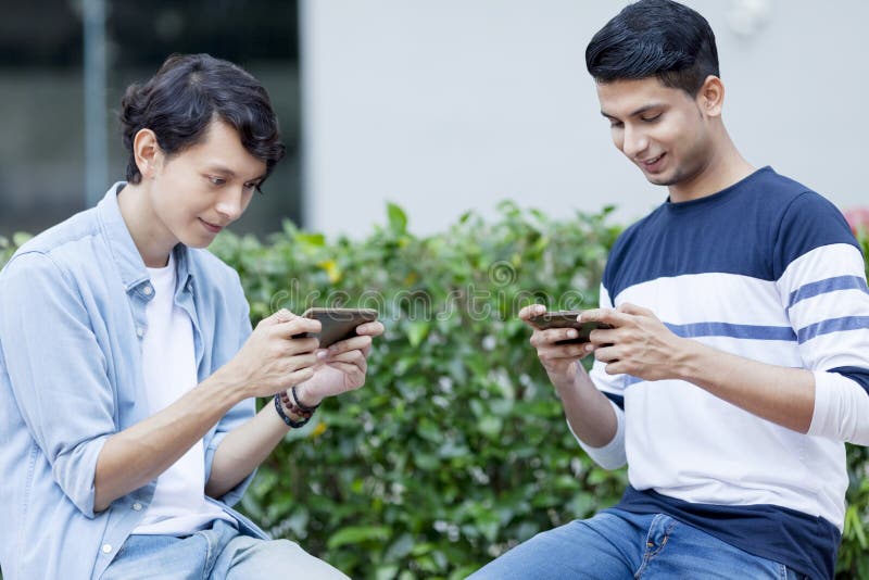 Two Young Men Playing Mobile Games. Modern Life Stock Photo - Image of ...