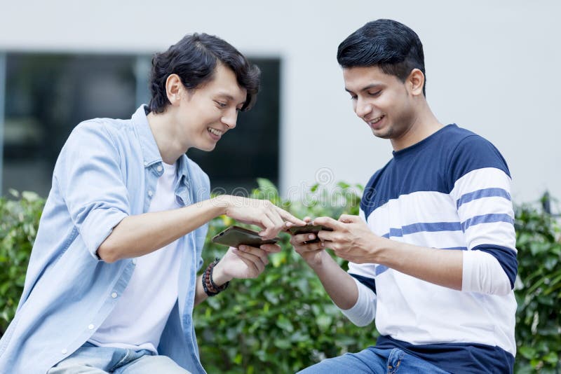 Two Young Men Playing Mobile Games. Modern Life Stock Image - Image of ...