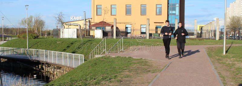 Two Young Men Running at the Park Editorial Photo - Image of jogging ...