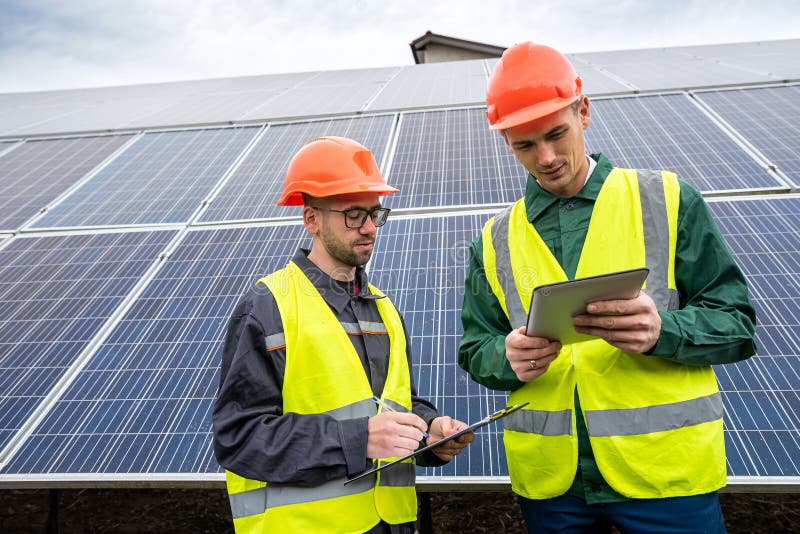 Two Young Men in Special Helmets Make Notes after Inspecting the Solar ...
