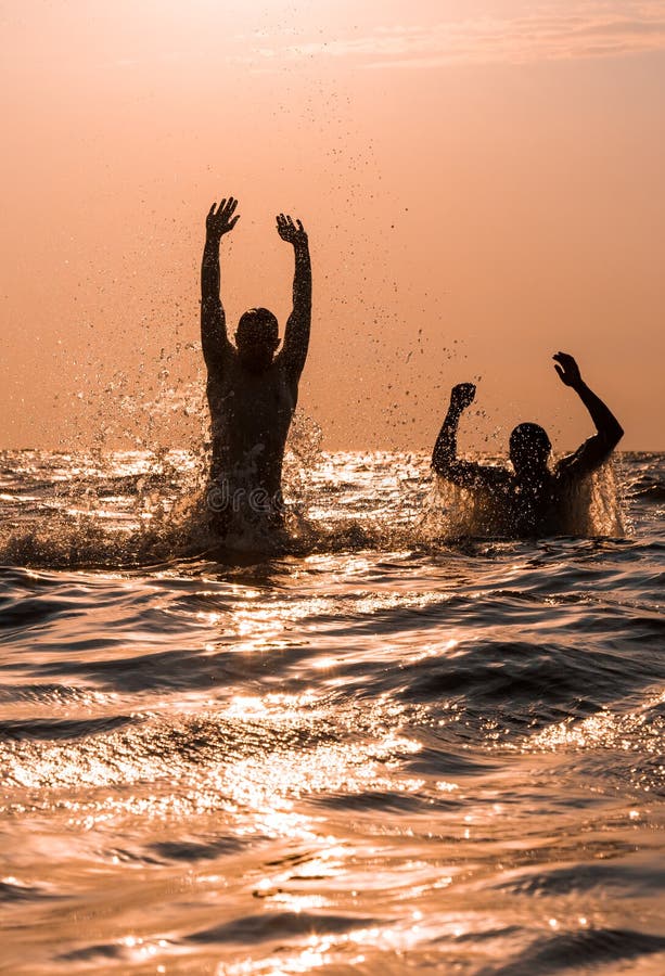 Two Young Men Splashing Water in the Sea Stock Image - Image of ocean ...
