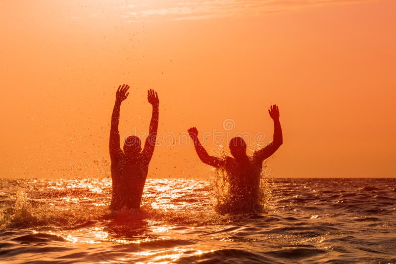 Two Young Men Splashing Water in the Sea Stock Photo - Image of ...