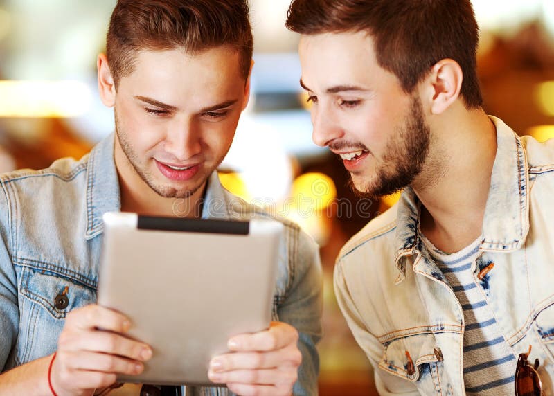 Two Young Men / Students Using Tablet Computer in Cafe Stock Image ...