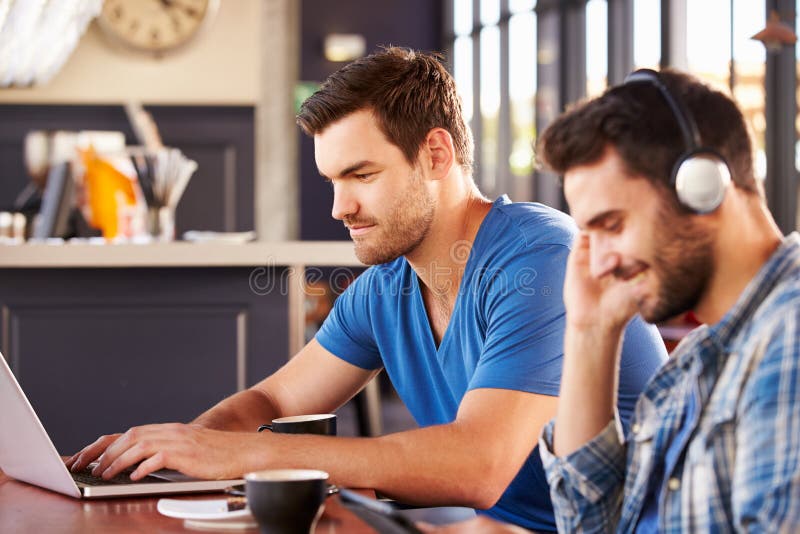 Two Young Men Working on Computers at a Coffee Shop Stock Image - Image ...