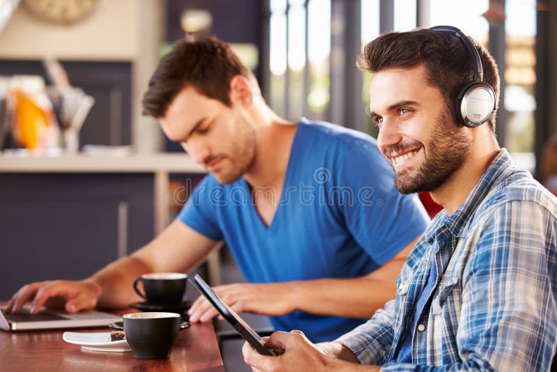 Two Young Men Working on Computers at a Coffee Shop Stock Image - Image ...