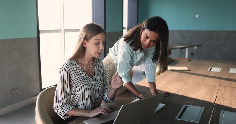 Two Women Colleagues Working on Joint Task Using Laptop Stock Video ...