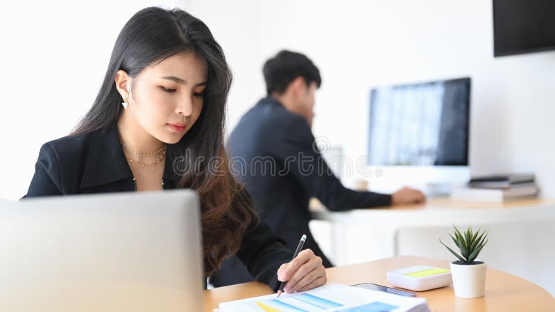 Two Young Office Worker Working on Their Computers. Stock Photo - Image ...