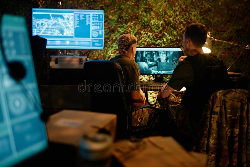 Two Young Officers Sitting by Workplace in Front of Computer Screen ...