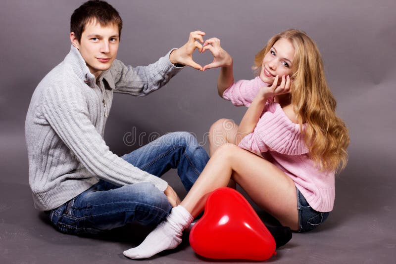 Two Young People Holding Heart-shaped Balloon Stock Image - Image of ...