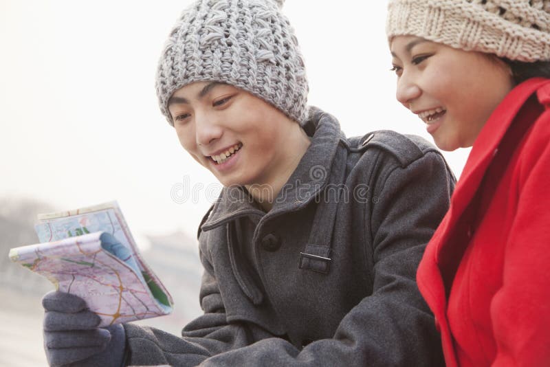 Two Young People Looking at Map Outside in Winter, Beijing Stock Image ...