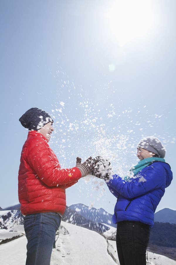 Two Young People Playing with Snow Stock Photo - Image of snow, winter ...