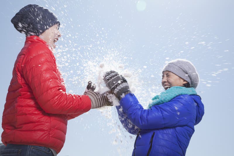 Two Young People Playing with Snow Stock Photo - Image of snow, winter ...