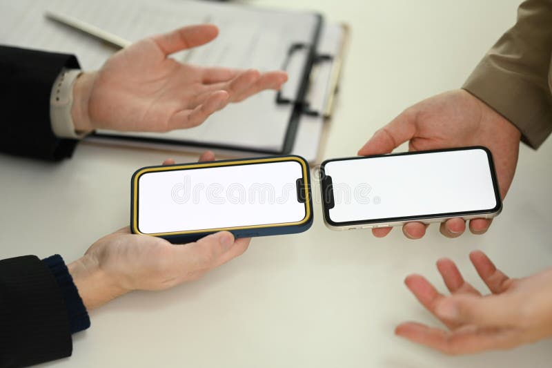 Two Young People Sharing Data between Smartphones. Technology, Data ...