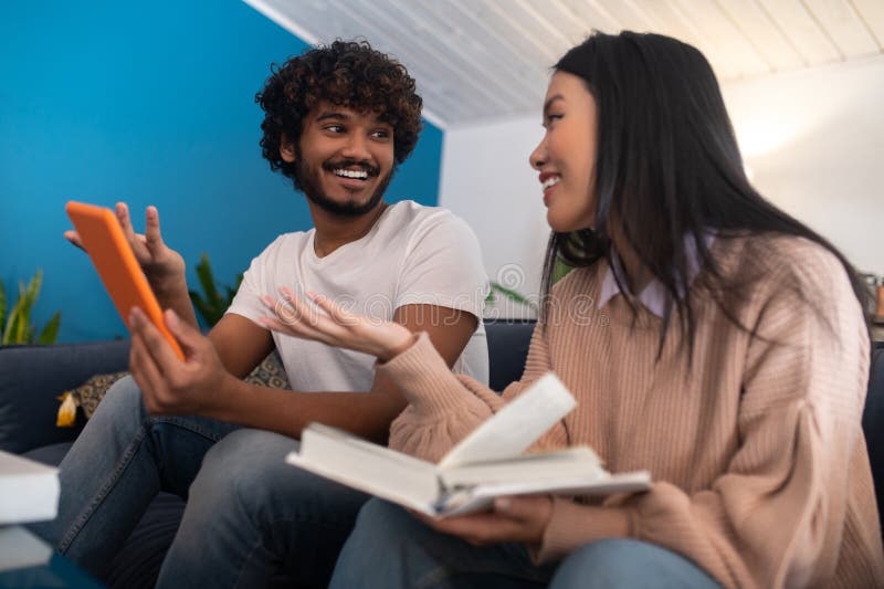 Two Young People Sitting on the Sofa and Studying Stock Image - Image ...