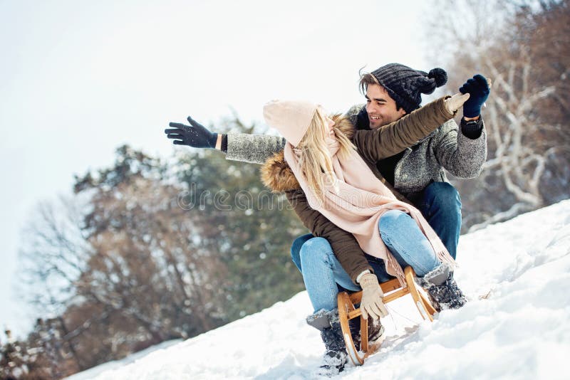 Two Young People Sliding On A Sled Stock Photo - Image of people ...