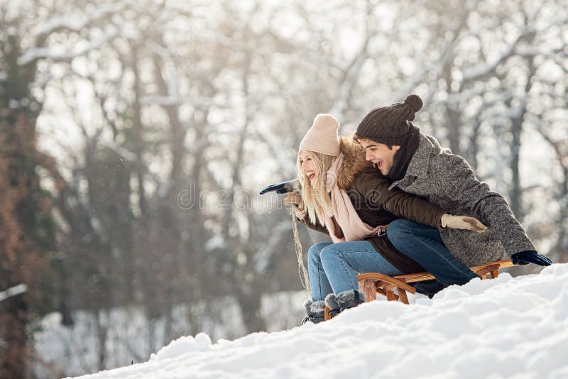 Two Young People Sliding on a Sled Stock Photo - Image of space ...