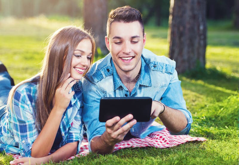 Two Young People with a Tablet Outside Stock Image - Image of male ...