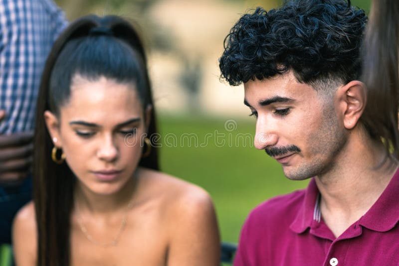 Two Young People Talking Surrounded by Other People in a Park Stock ...