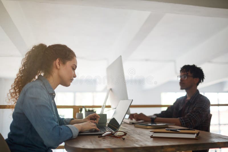 Two Young People Using Computers in Coworking Space Stock Photo - Image ...