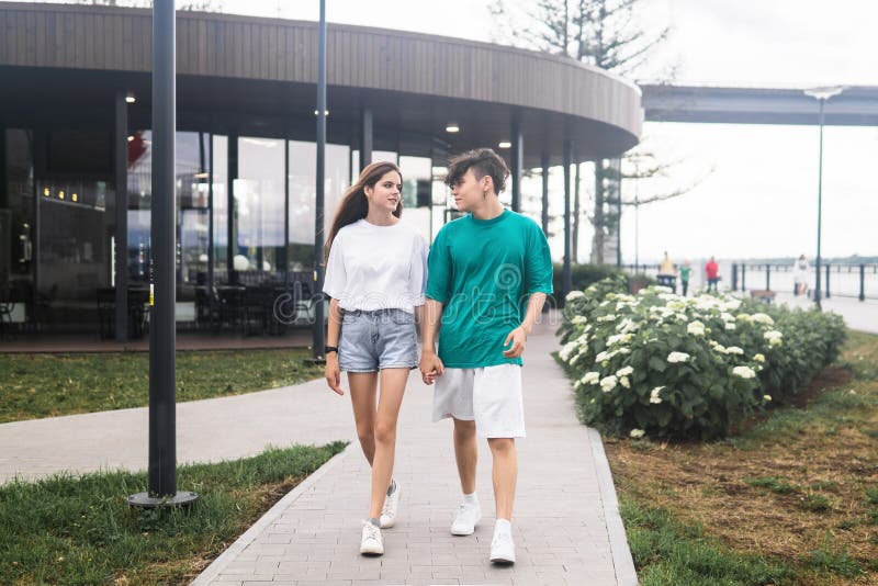 Two Young People are Walking and Talking in a City Coastal Park Stock Photo - Image of handsome ...