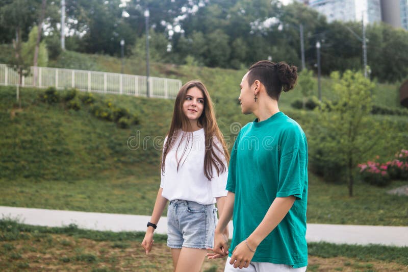 Two Young People are Walking and Talking in a City Park Stock Image ...