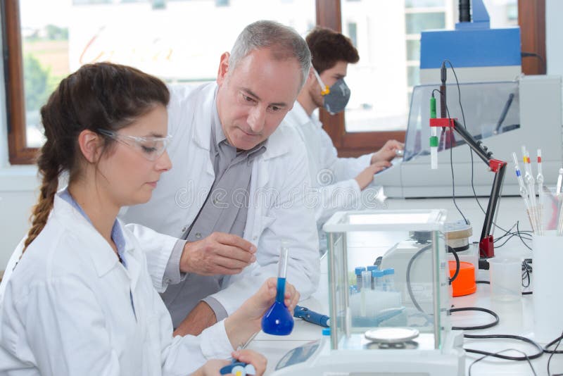 Two Young Researchers Carrying Out Experiments in Lab Stock Photo ...