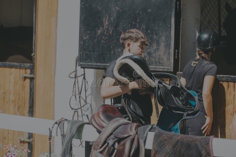 Young Horse Riders Preparing Equipment in Stable Setting Stock Image ...