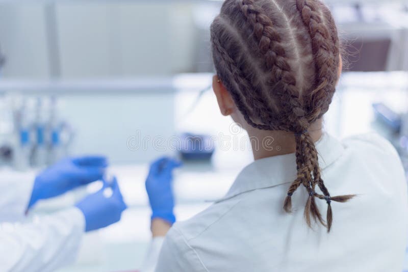 Two Young Scientists Working in a Laboratory and Doing Research ...