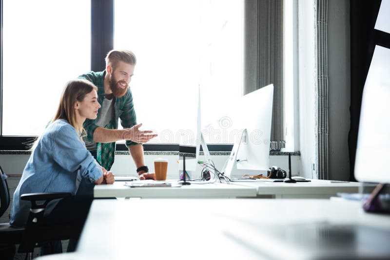 Two Young Smiling Colleagues Work in Office Stock Image - Image of ...