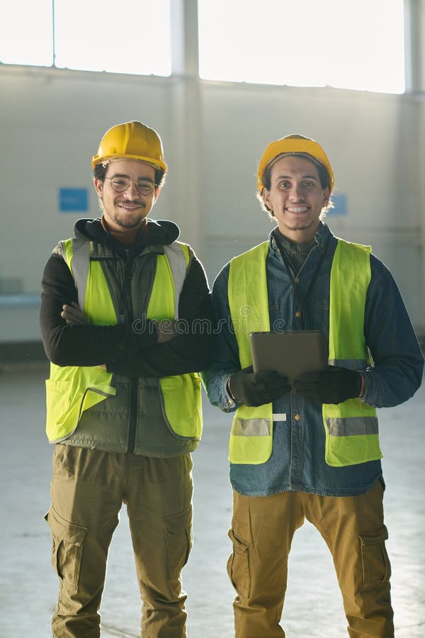 Two Young Smiling Multiethnic Engineers Standing in Front of Camera ...