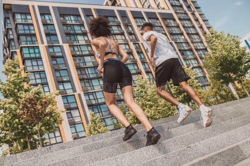 Two Young Sportsmen Running and Looking Energized Stock Image - Image ...