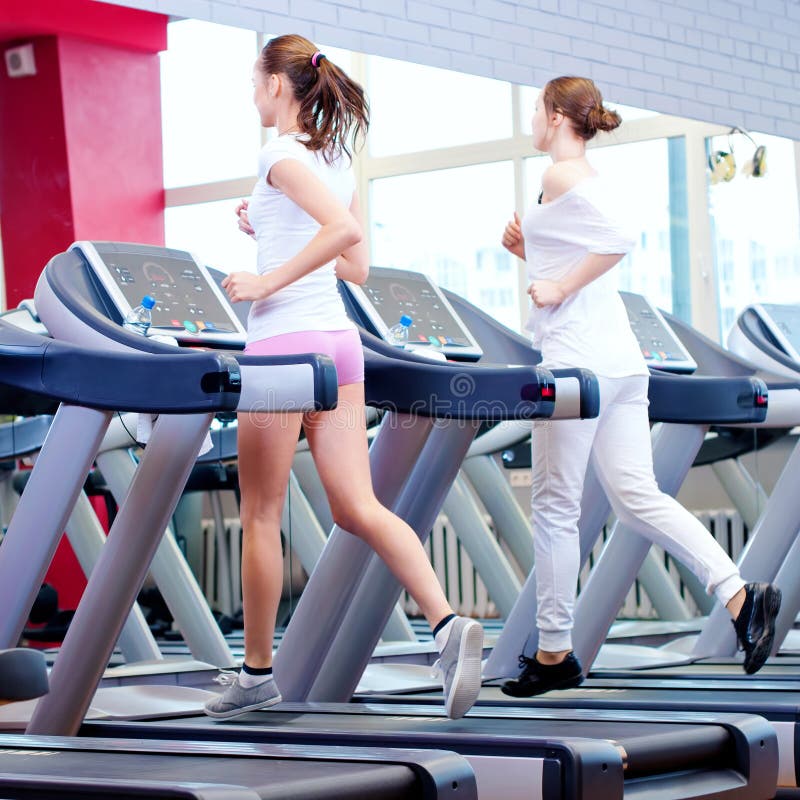 Two Young Sporty Women Run on Machine Stock Photo - Image of beauty ...