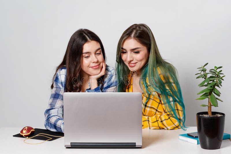Two Young Student Girls with Laptops Studying Together at the Table ...