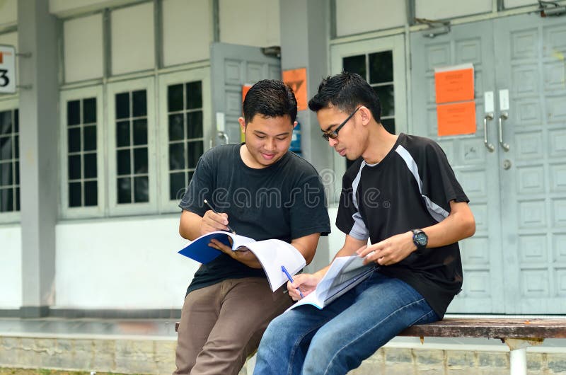 Two Young Student Reading Books Stock Photo - Image of field, person ...
