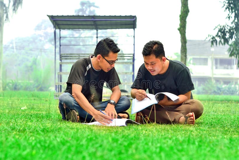 Two Young Student Reading Books Stock Photo - Image of outdoors, park ...